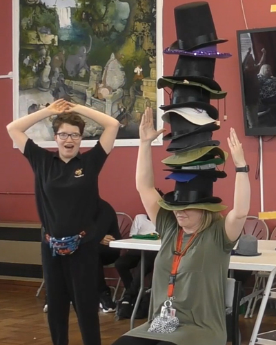 Students stack 15 hats on teacher's head to break record | Guinness ...
